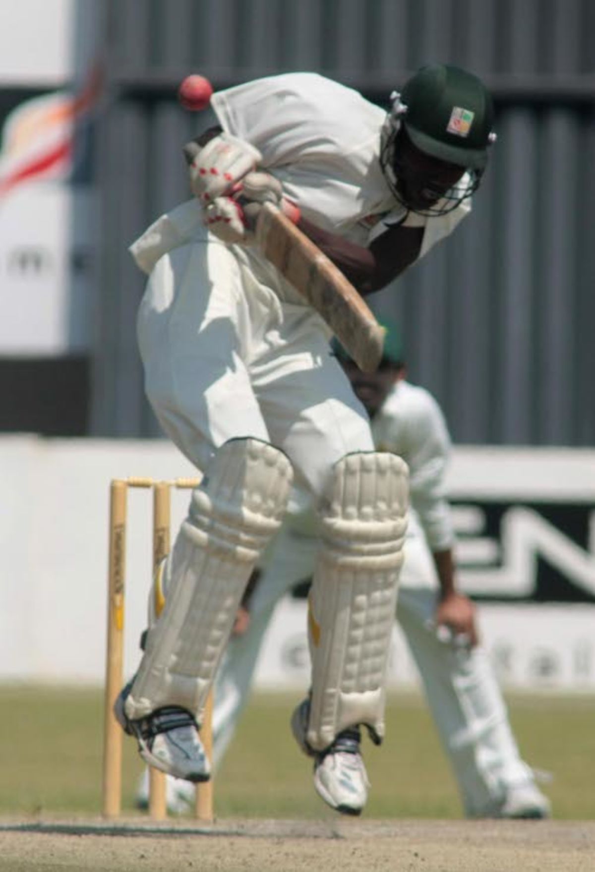 Trevor Garwe gets into a tangle while facing a rising delivery ...