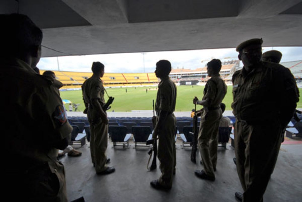 Police officers stand guard during the game between New Zealand A and ...