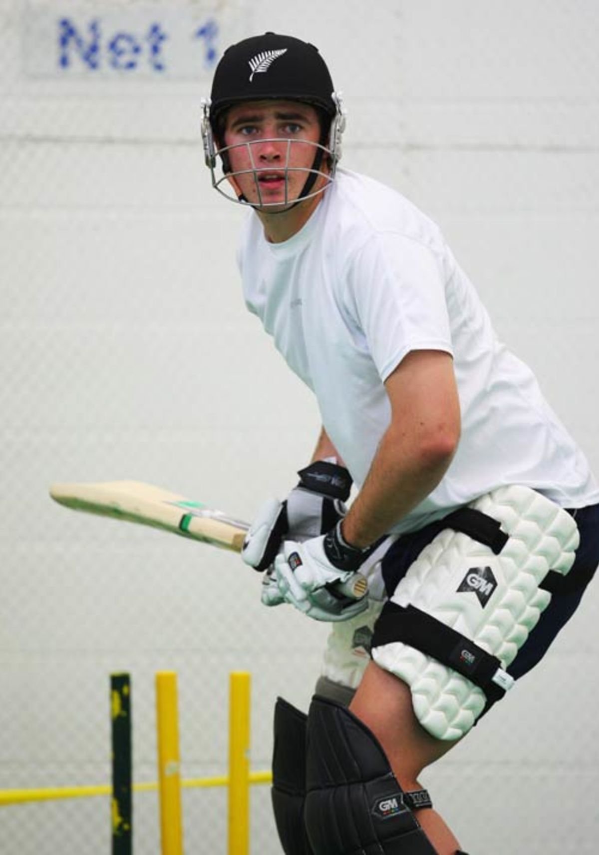 Auctioneer Charles Leski holds up the first cricket bat used by Sir ...