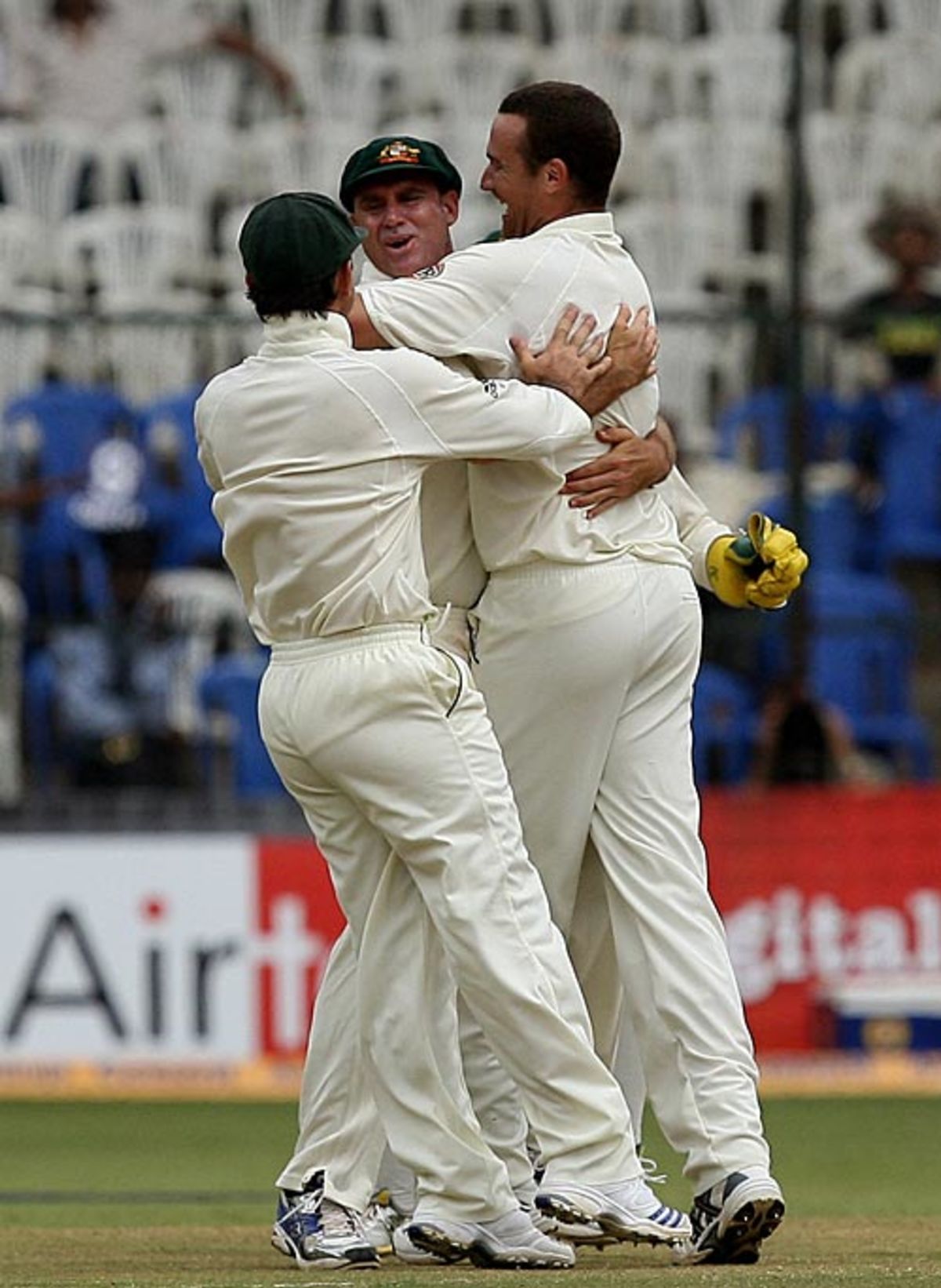 Stuart Clark is mobbed by team-mates after picking up Virender Sehwag's ...