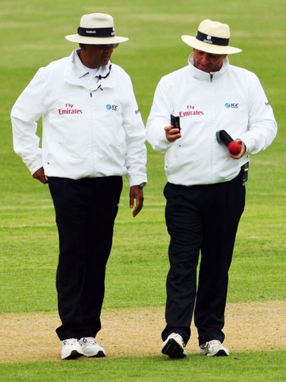 Umpires Amish Sahiba and Mark Benson have a look at the light meter ...