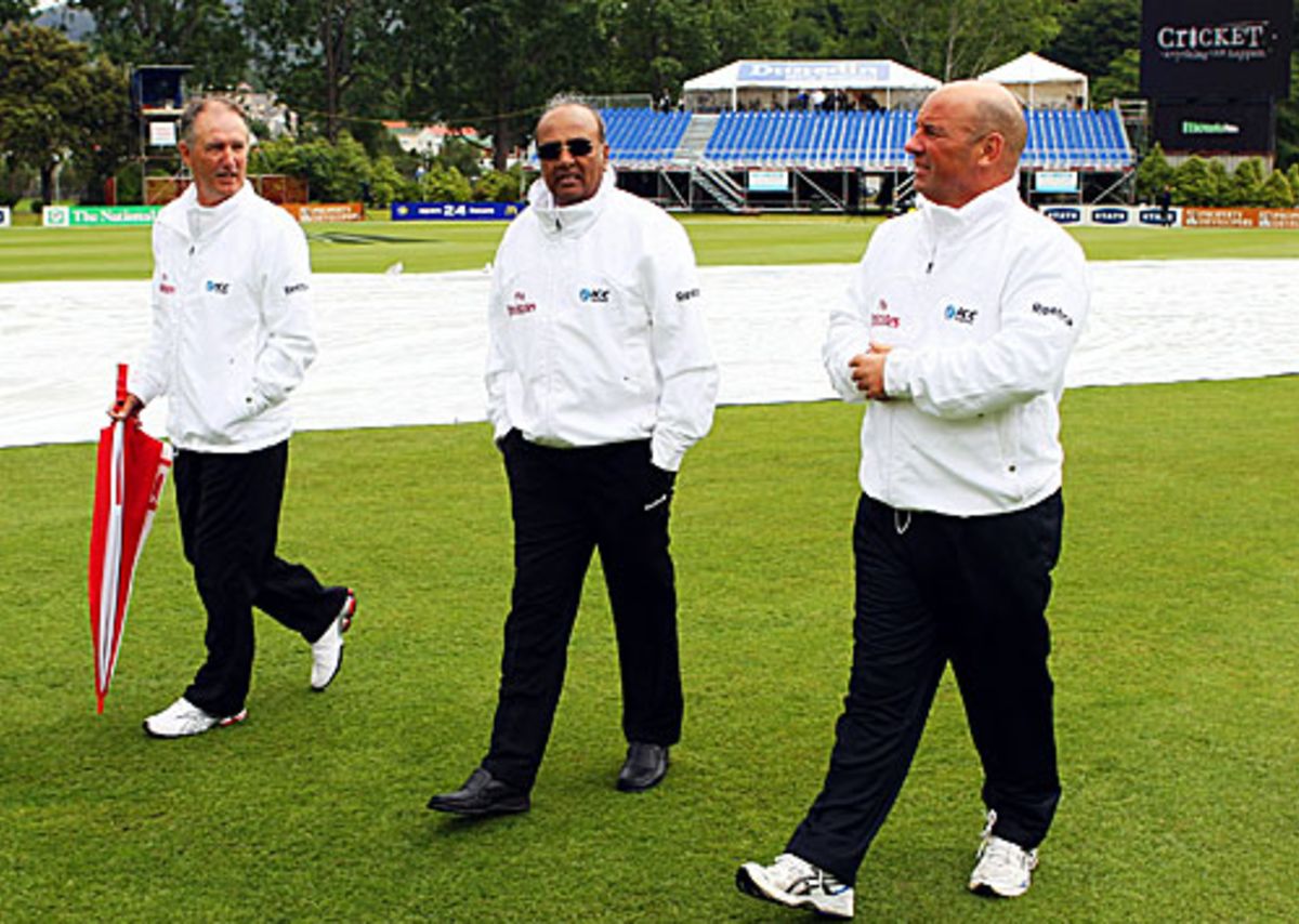 Umpires Tony Hill, Amiesh Saheba and Mark Benson inspect the wet ...