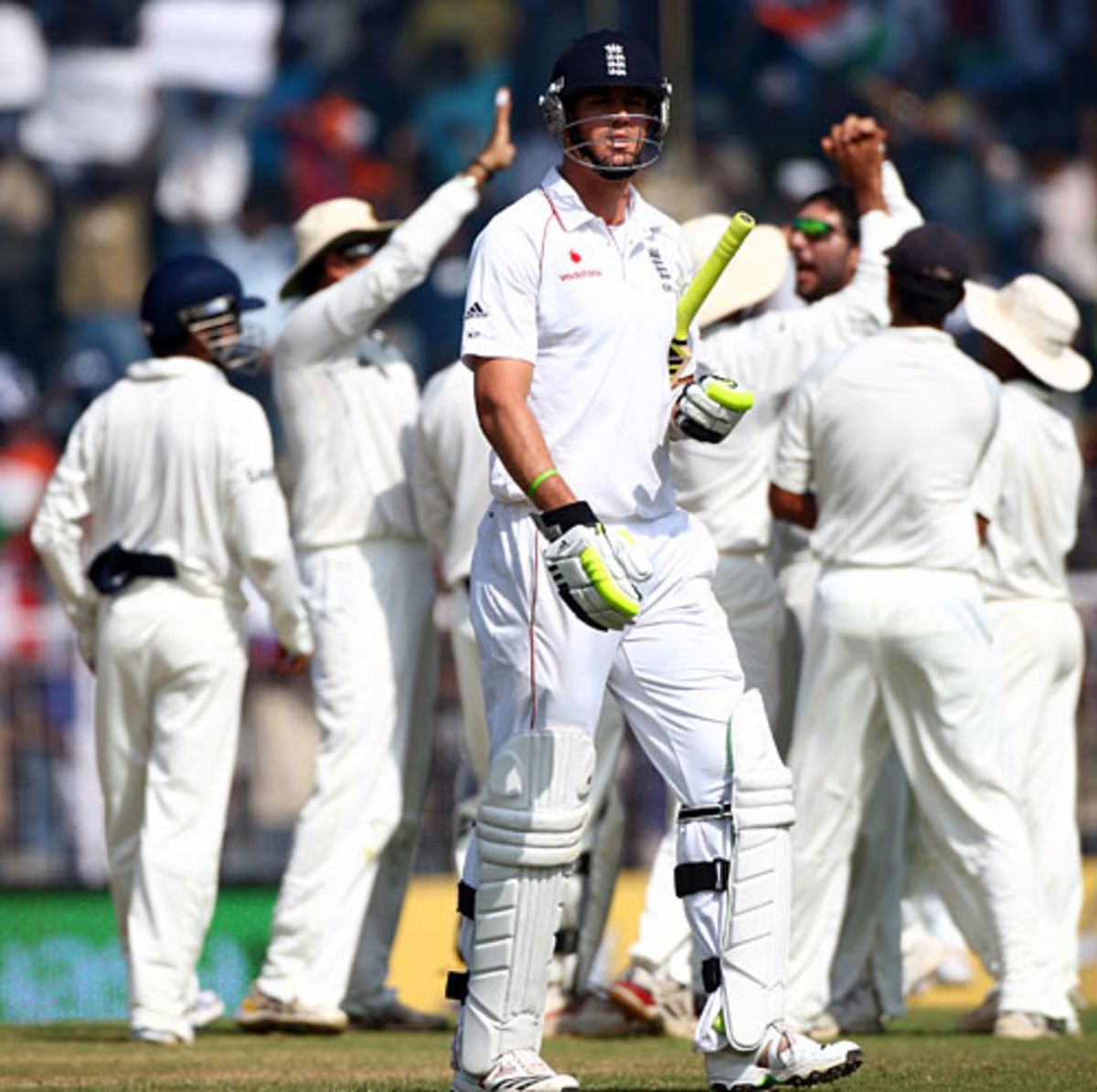 Indian players celebrate in the background as Kevin Pietersen trudges ...
