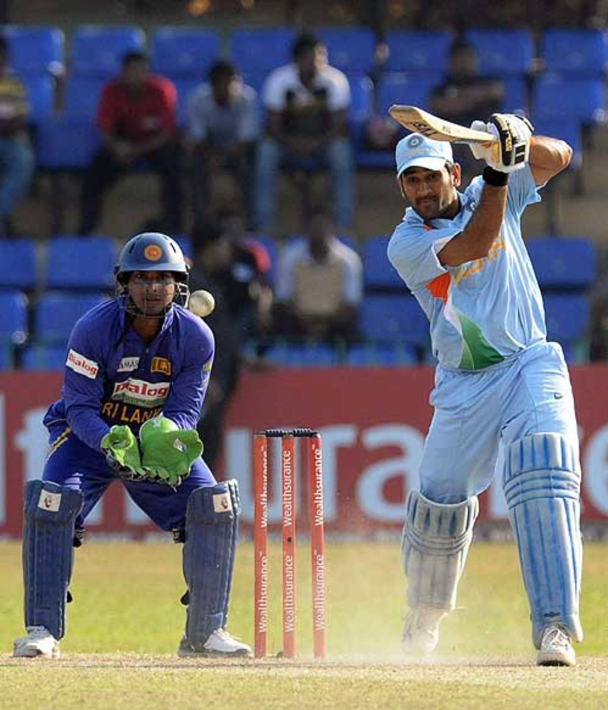 Mahendra Singh Dhoni punches during his fifty | ESPNcricinfo.com