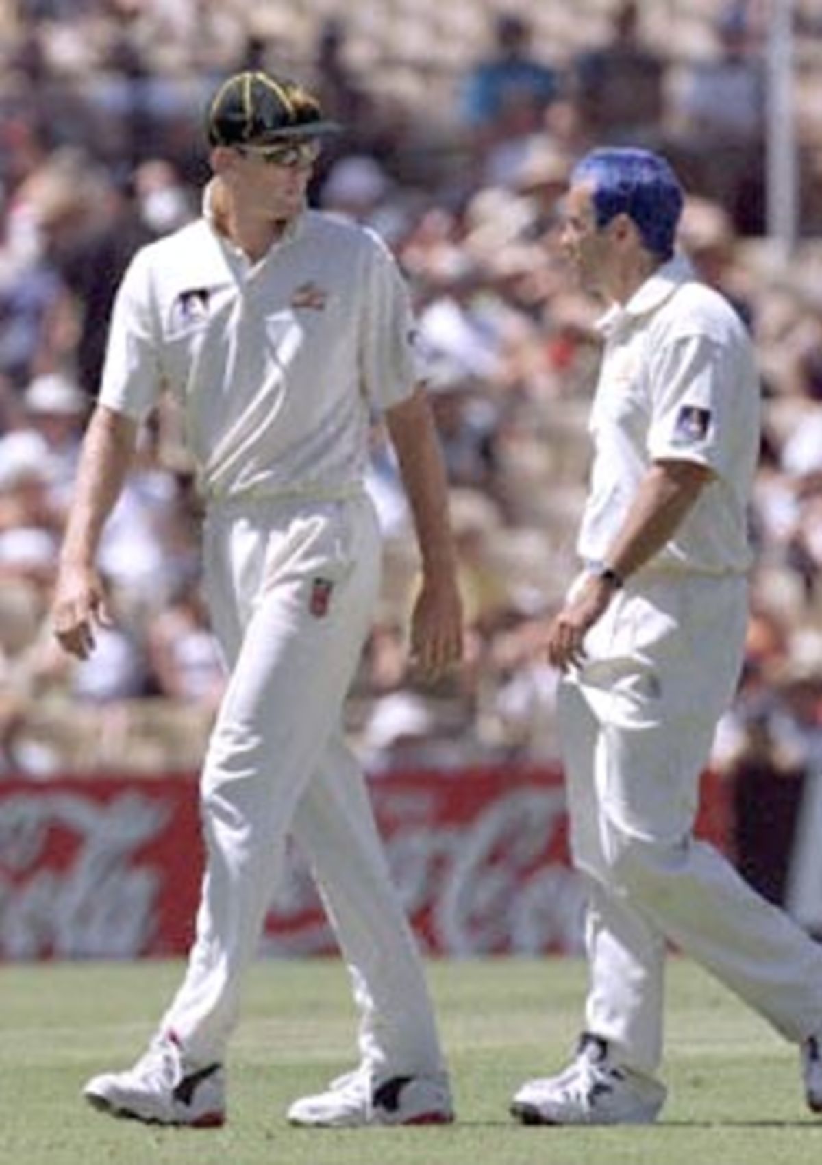 Aussie bowlers Colin Miller and Glenn McGrath walk off the field ...
