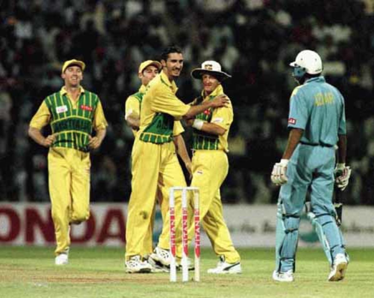 Groundstaff attempt to clear the mess caused by the crowd ...