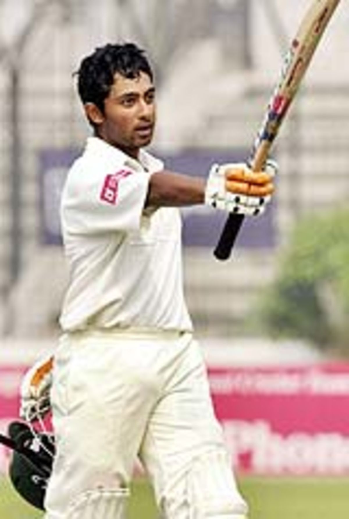 Nafis Iqbal acknowledges the applause after reaching his hundred ...