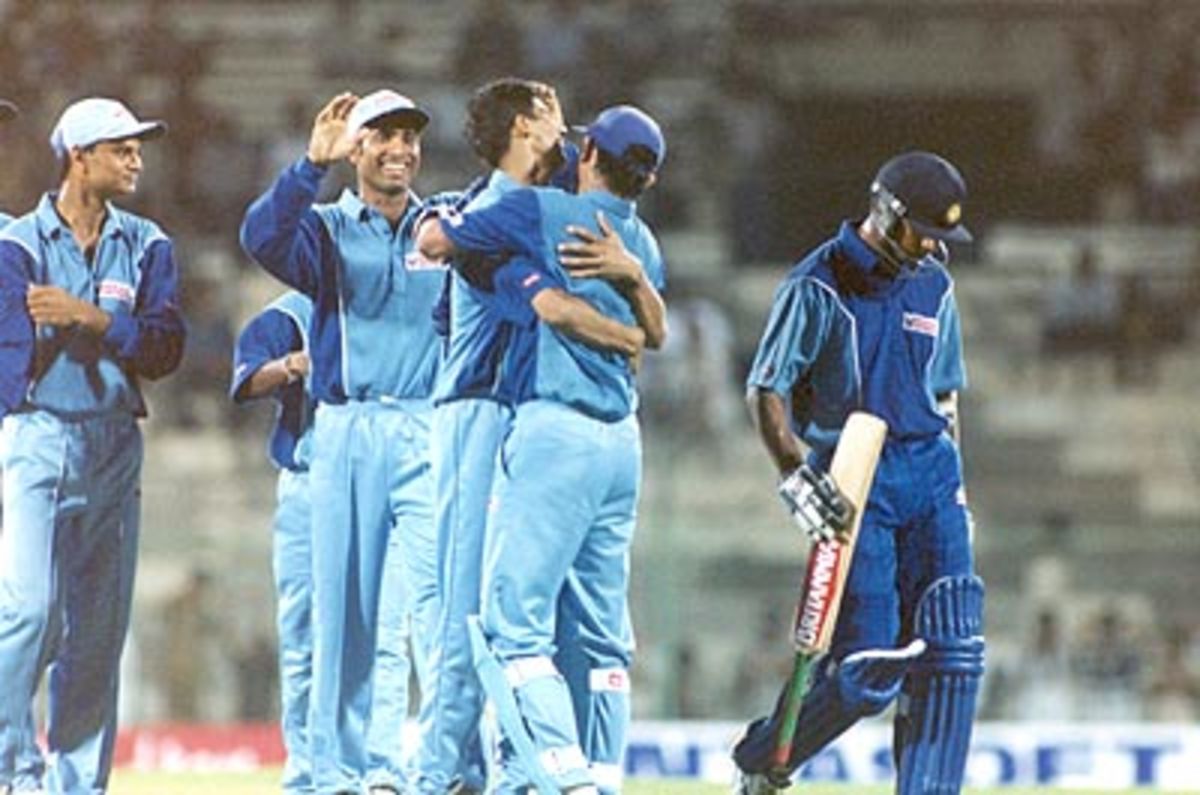 Dravid takes a rueful look at the bat after edging Nehra to the keeper ...