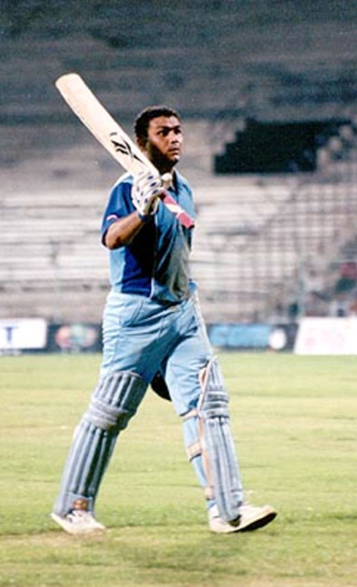 Shewag acknowledges the cheers as he returns to the pavilion ...