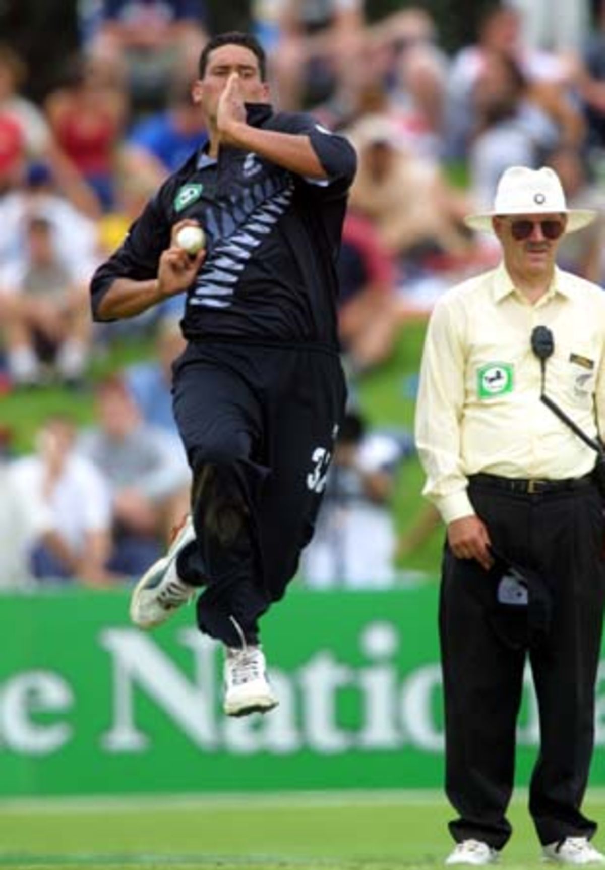 Tuffey delivers while umpire Watkin looks on | ESPNcricinfo.com