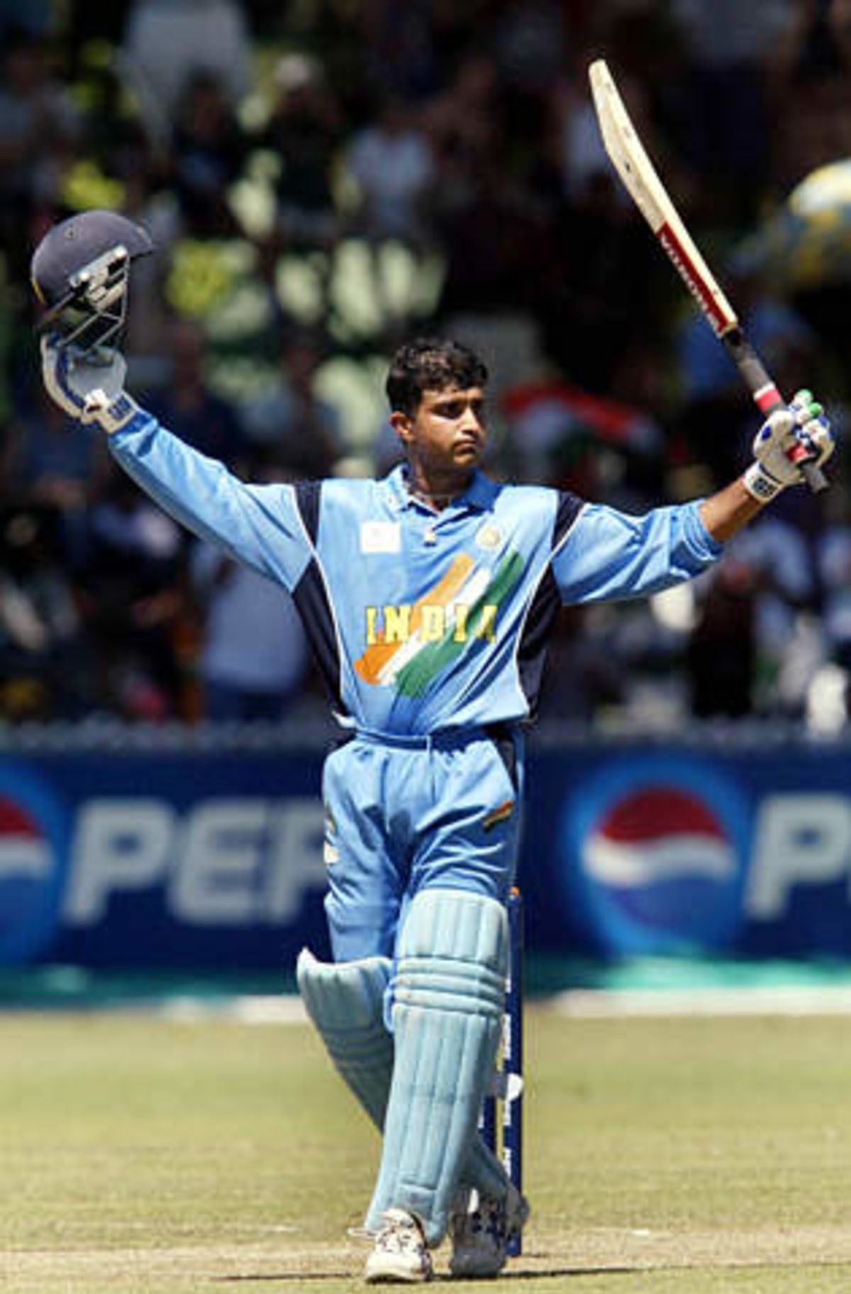 Sourav Ganguly raises his bat to acknowledge the cheering crowd after ...