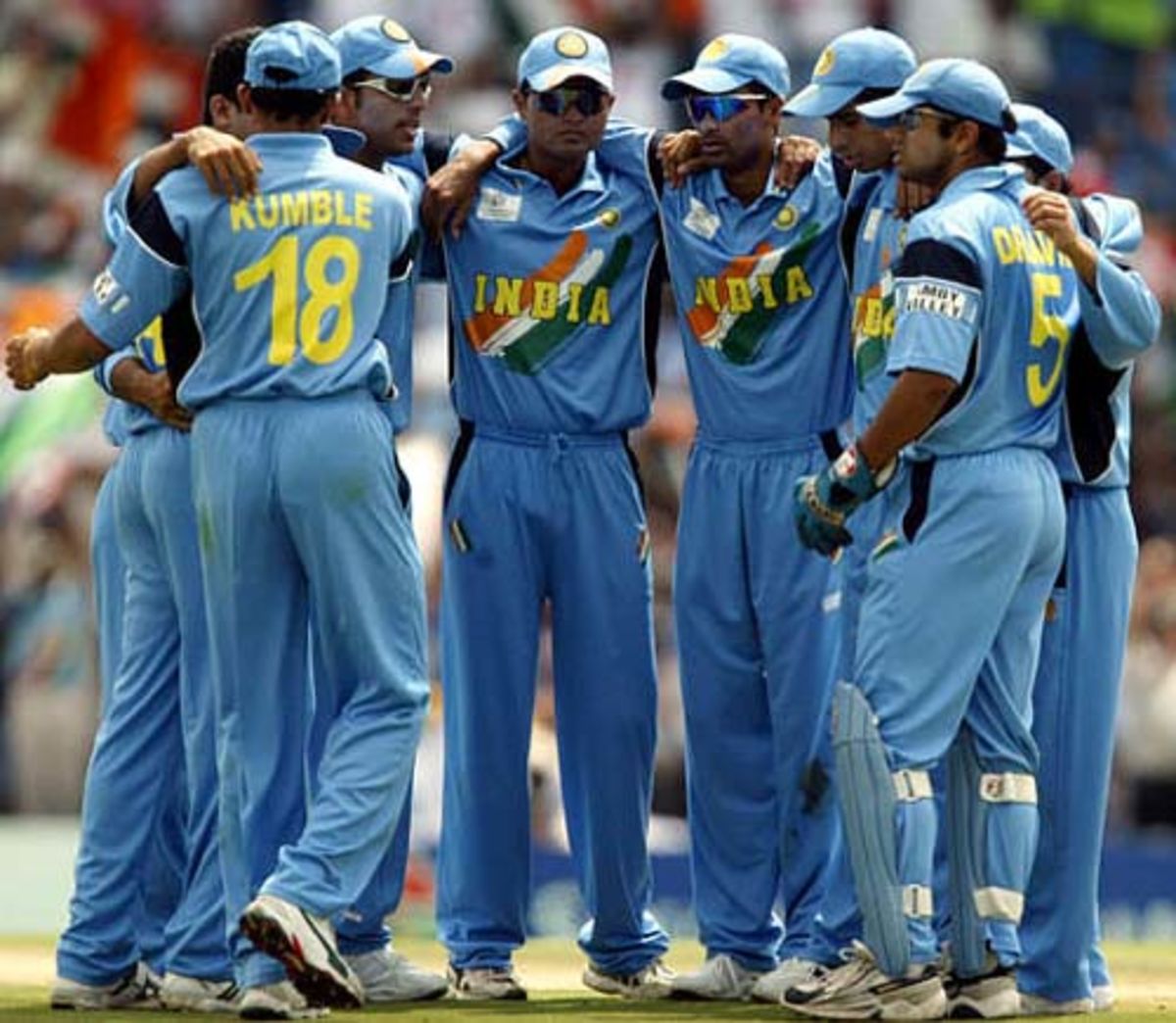 Indian players huddle together as they celebrate the dismissal of ...