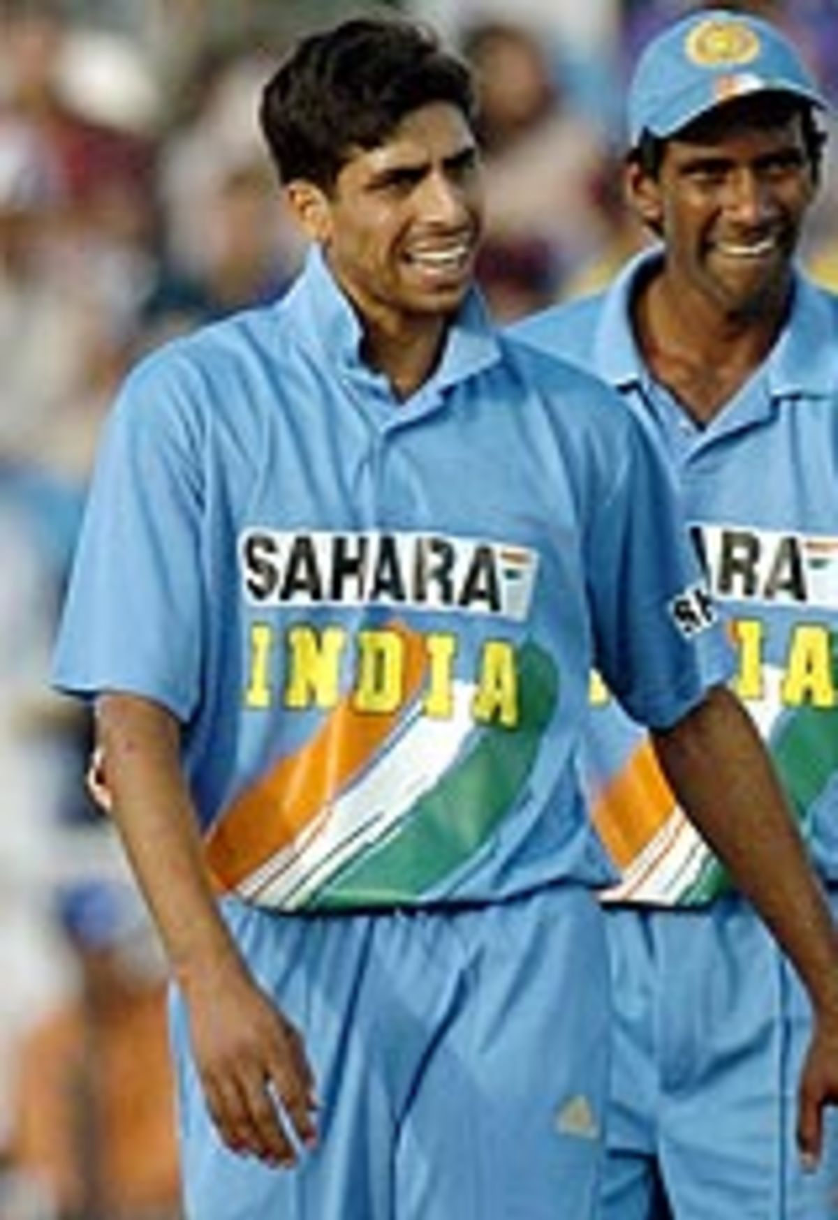 Ashish Nehra walks away after hurting his hand, with L Balaji in the ...