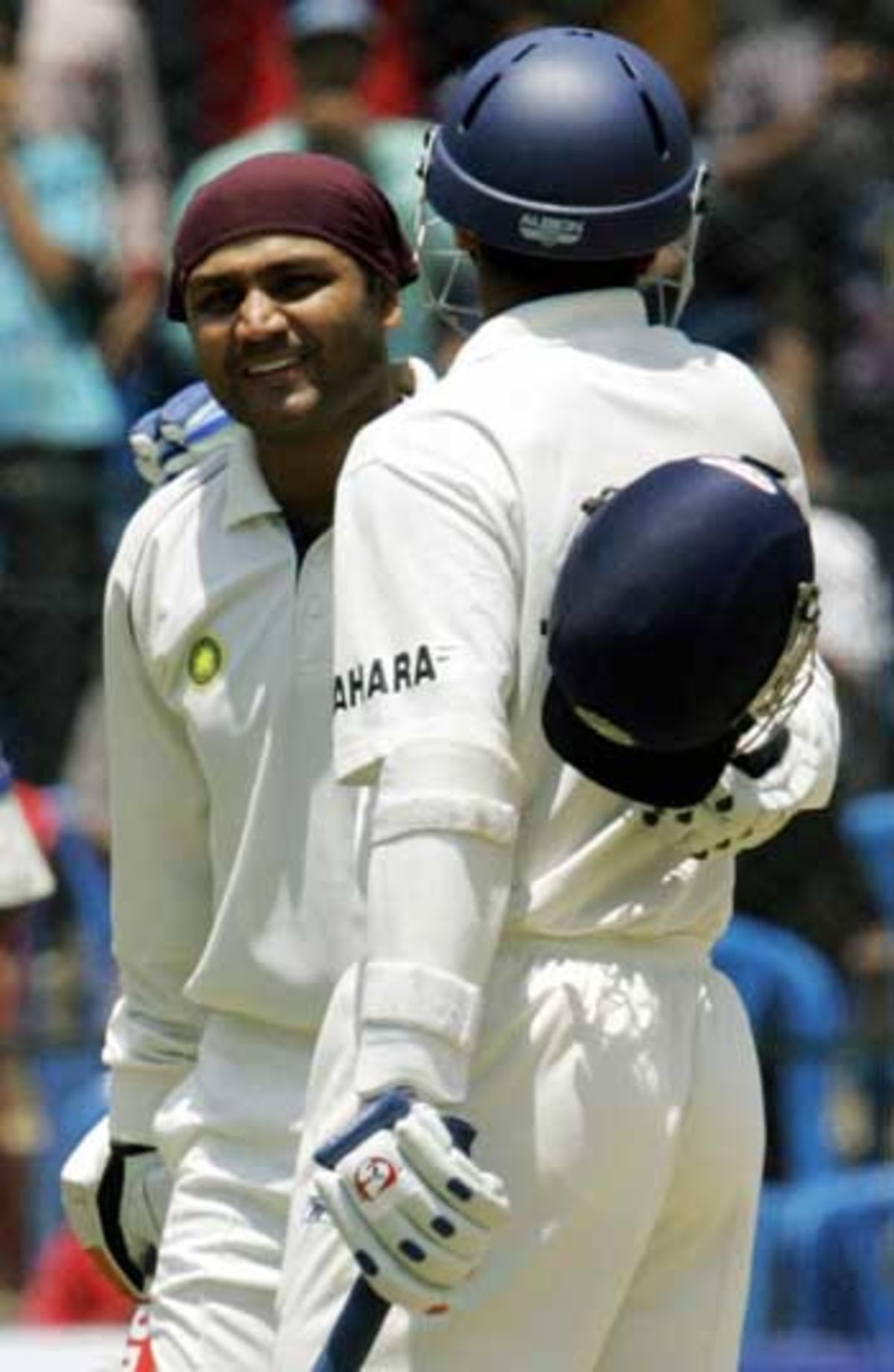 Virender Sehwag raises his bat to the crowd after reaching his century ...