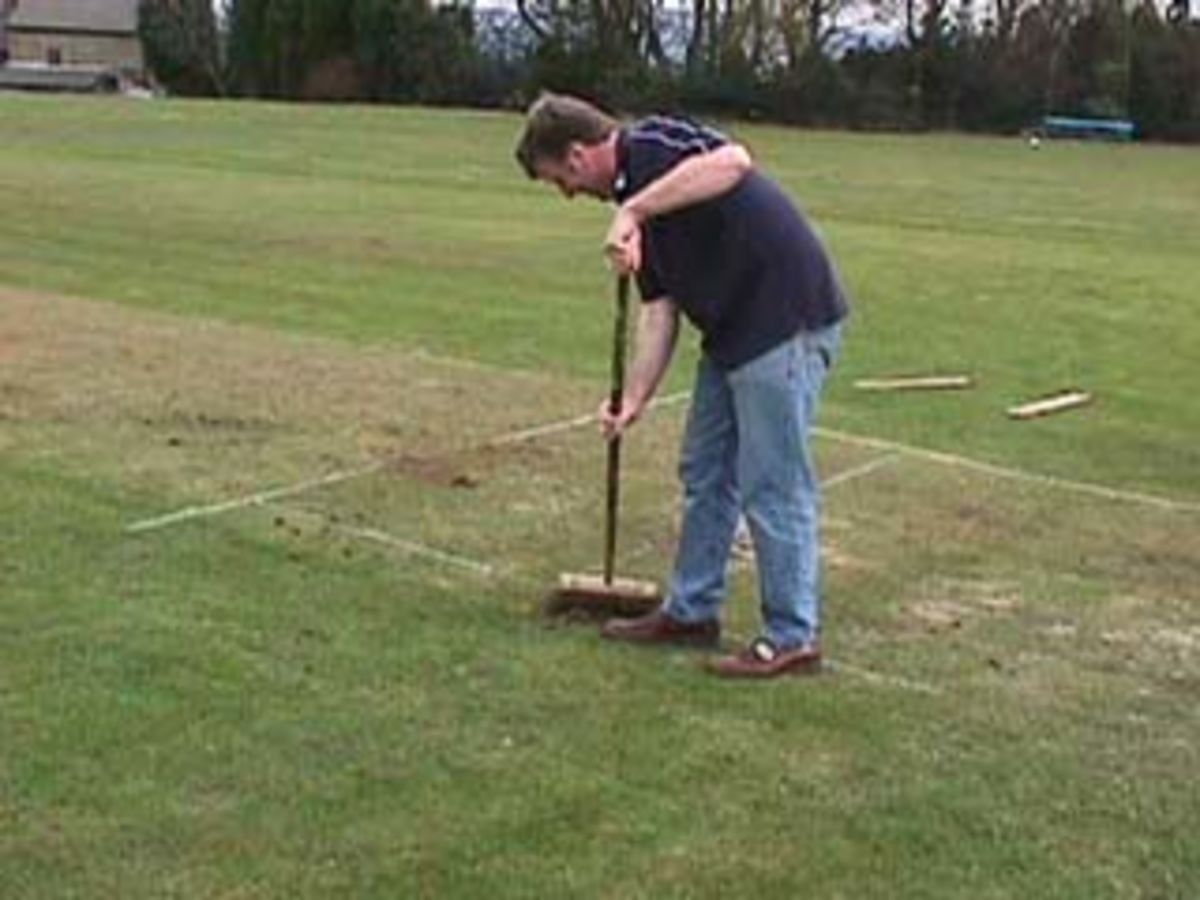 The Great Harwood groundsman begins repair work at the tea interval ...