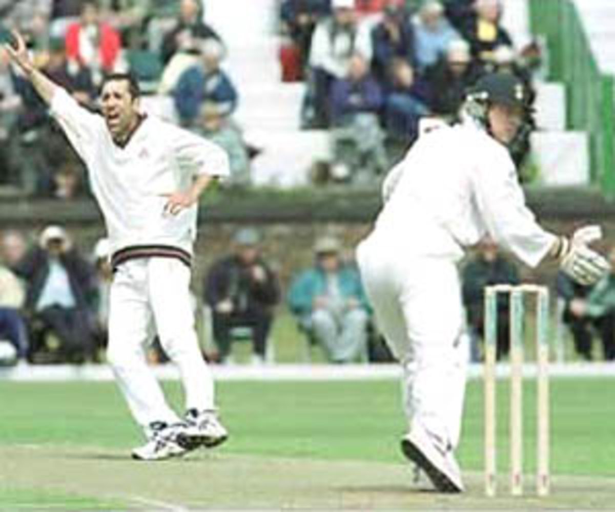 Smethurst is all smiles after picking the wicket of Robin Smith ...