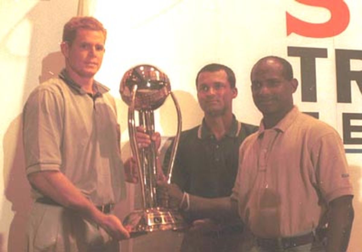 Pollock holding the Singer Trophy with Moin Khan and Jayasuriya ...