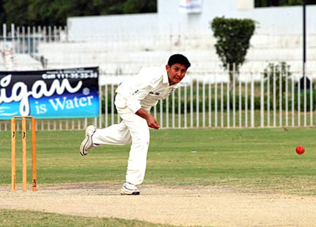 Mohammad Emran of Qatar bowls while a bird does a flypast ...