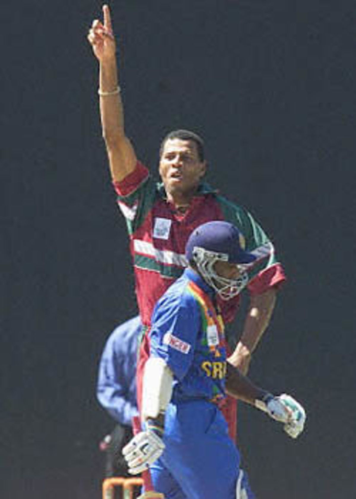 West Indies paceman Dillon celebrates on Jayasuriya's wicket ...