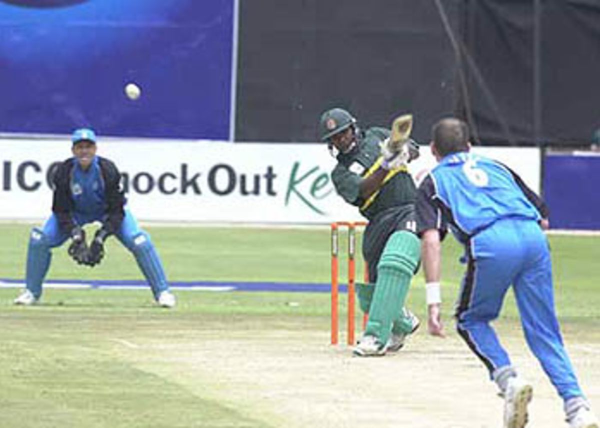 Aminul Islam hits a ferocious drive off Caddick as keeper Stewart looks ...