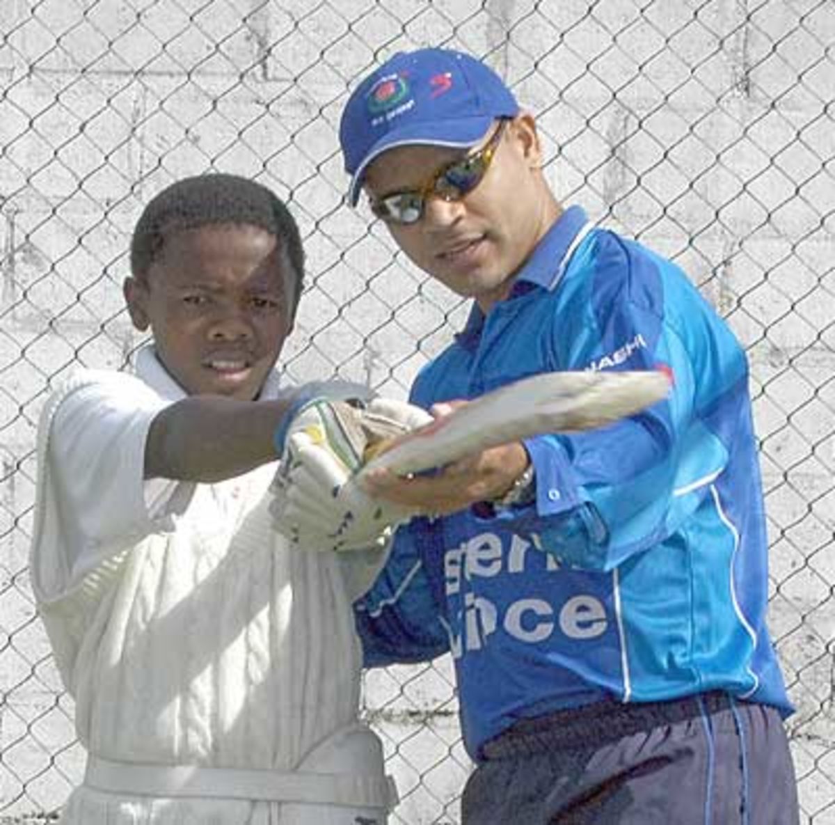 WP captain Ashwell Prince shows a young Gugulethu player how to hook ...