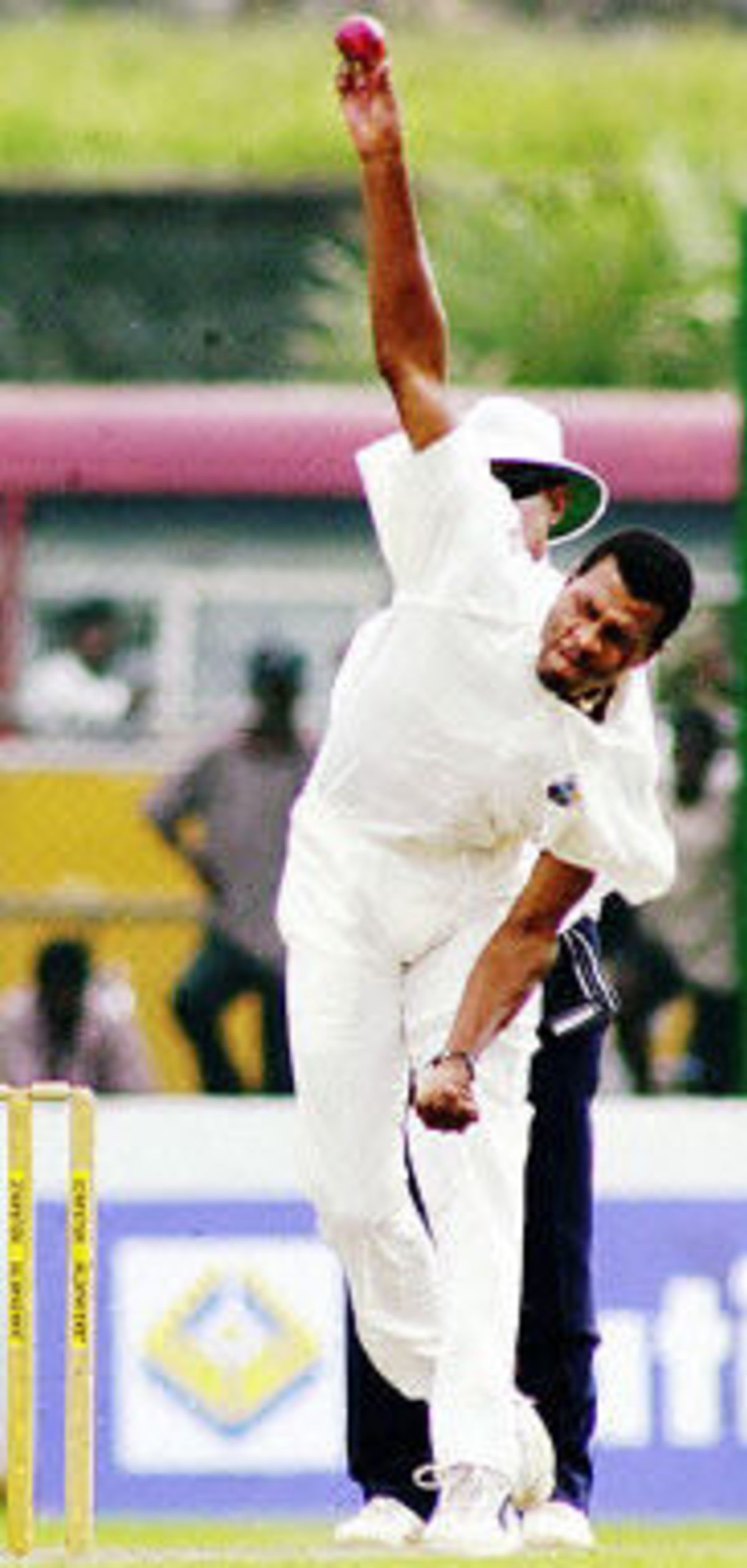 Mervyn Dillon delivers a ball during the second day of the first ...