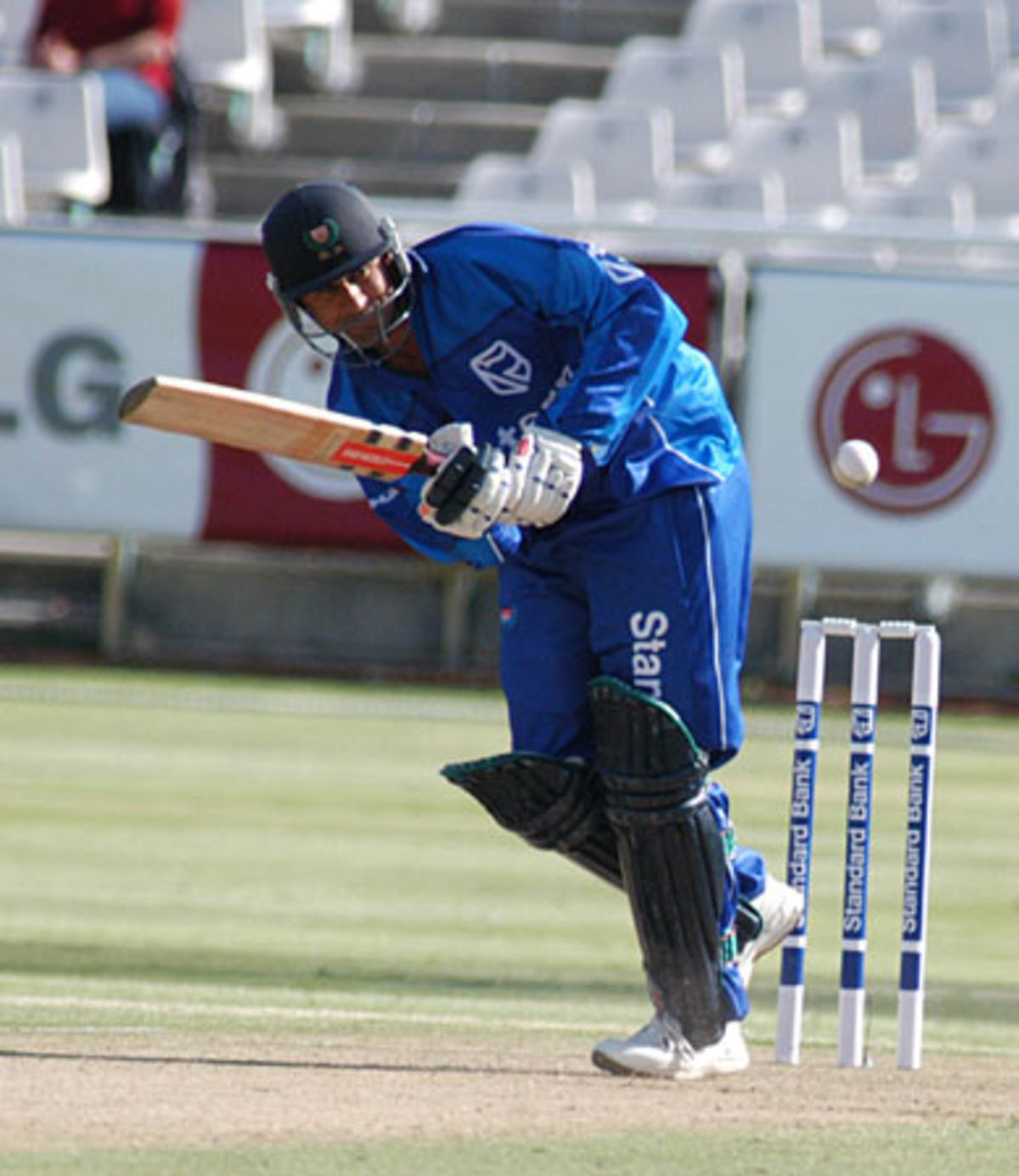 Andrew Puttick plays through the legside with Mornantau Hayward diving ...