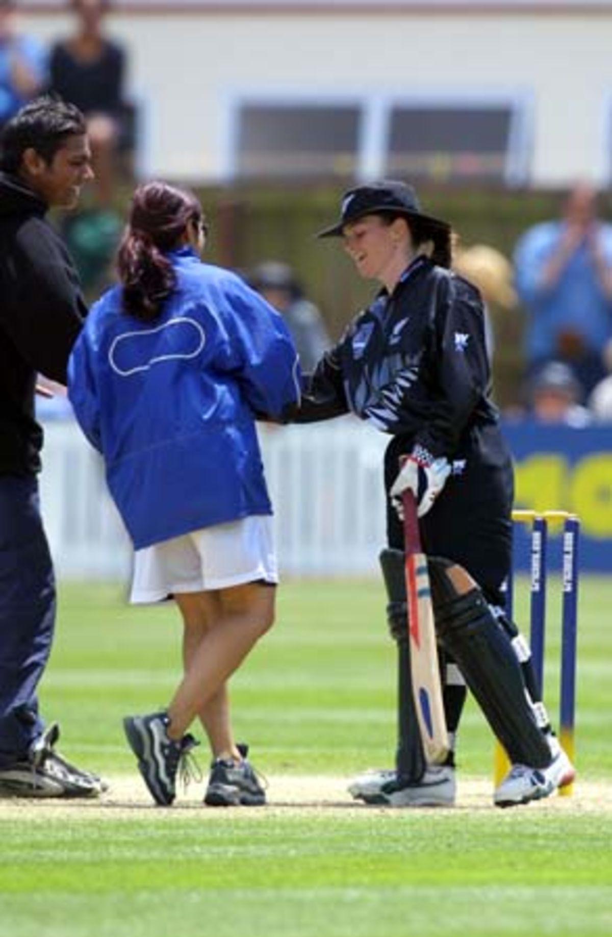 White Fern captain Emily Drumm raises her bat to her team on the ...