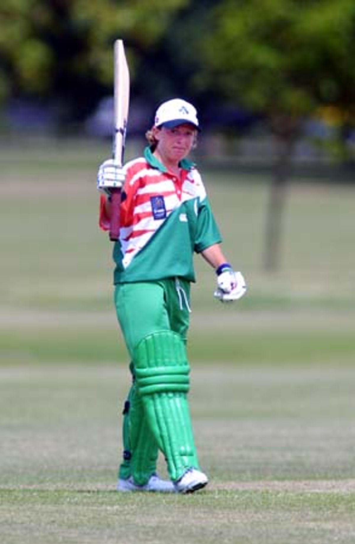 Anne Linehan raises her bat after she reaches a half-century ...