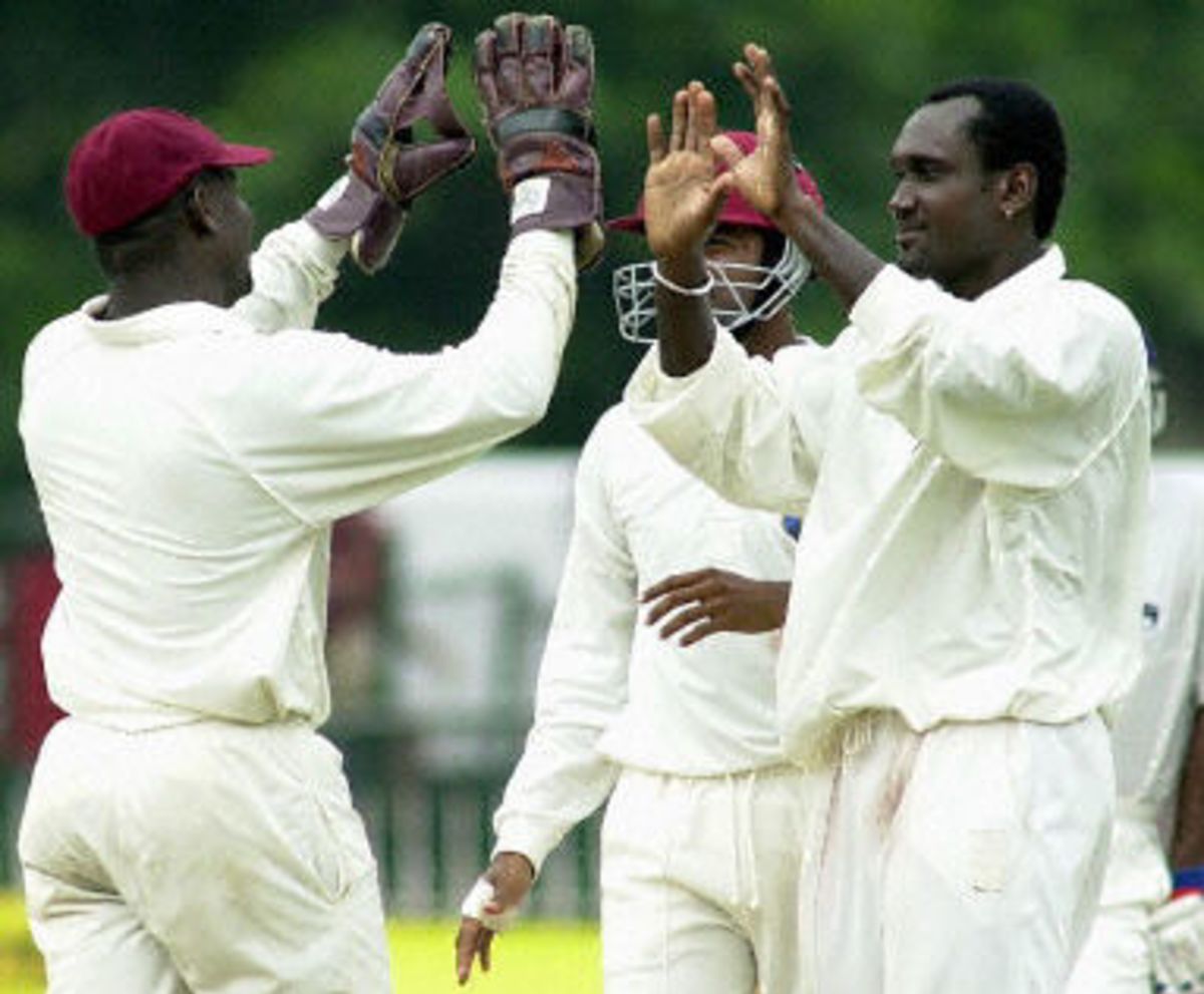 skipper Carl Hooper celebrates with Ridley Jacobs after taking his 100 ...