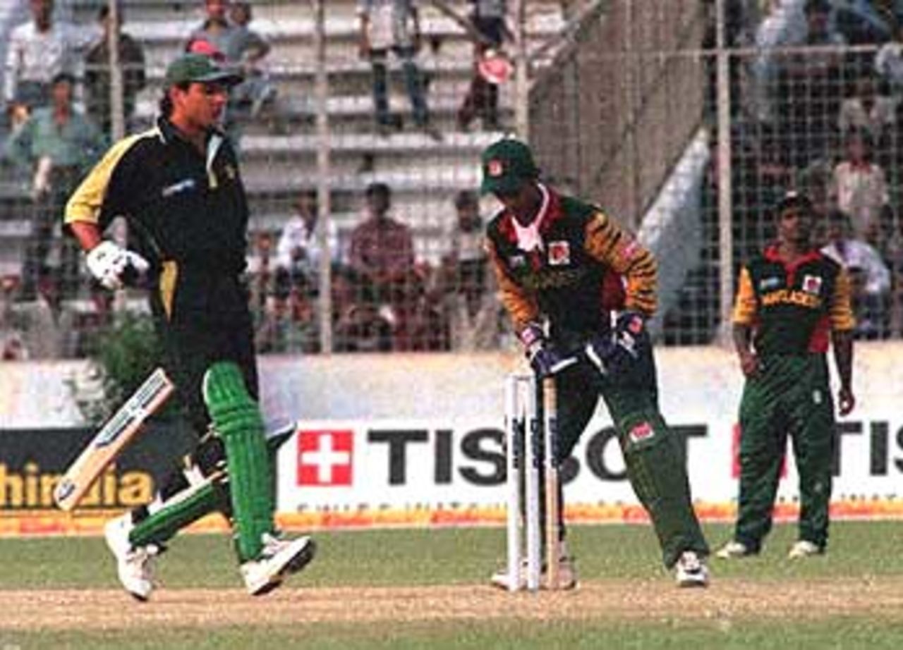 Wicketkeeper Khaled Mashud watches Youhana push the ball down leg side ...