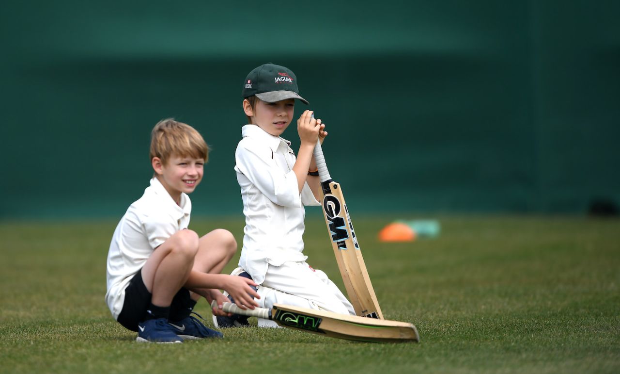 Young cricketers look on during a junior training session at The ...
