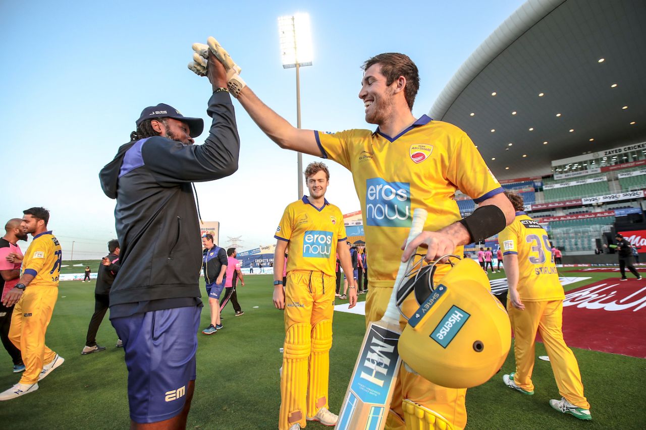 Jamie Overton gets a high-five from Chris Gayle after his 11-ball 38 ...
