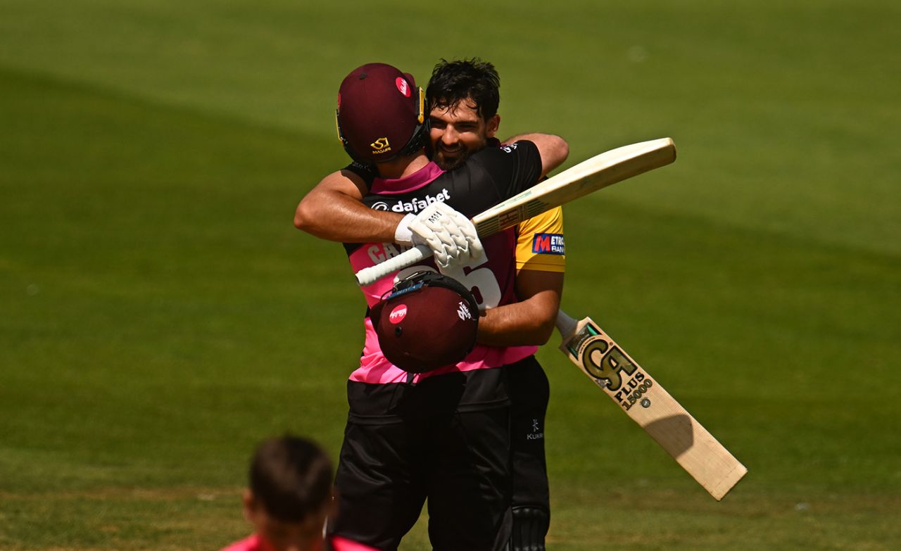 Andrew Umeed celebrates his century with team-mate Curtis Campher ...