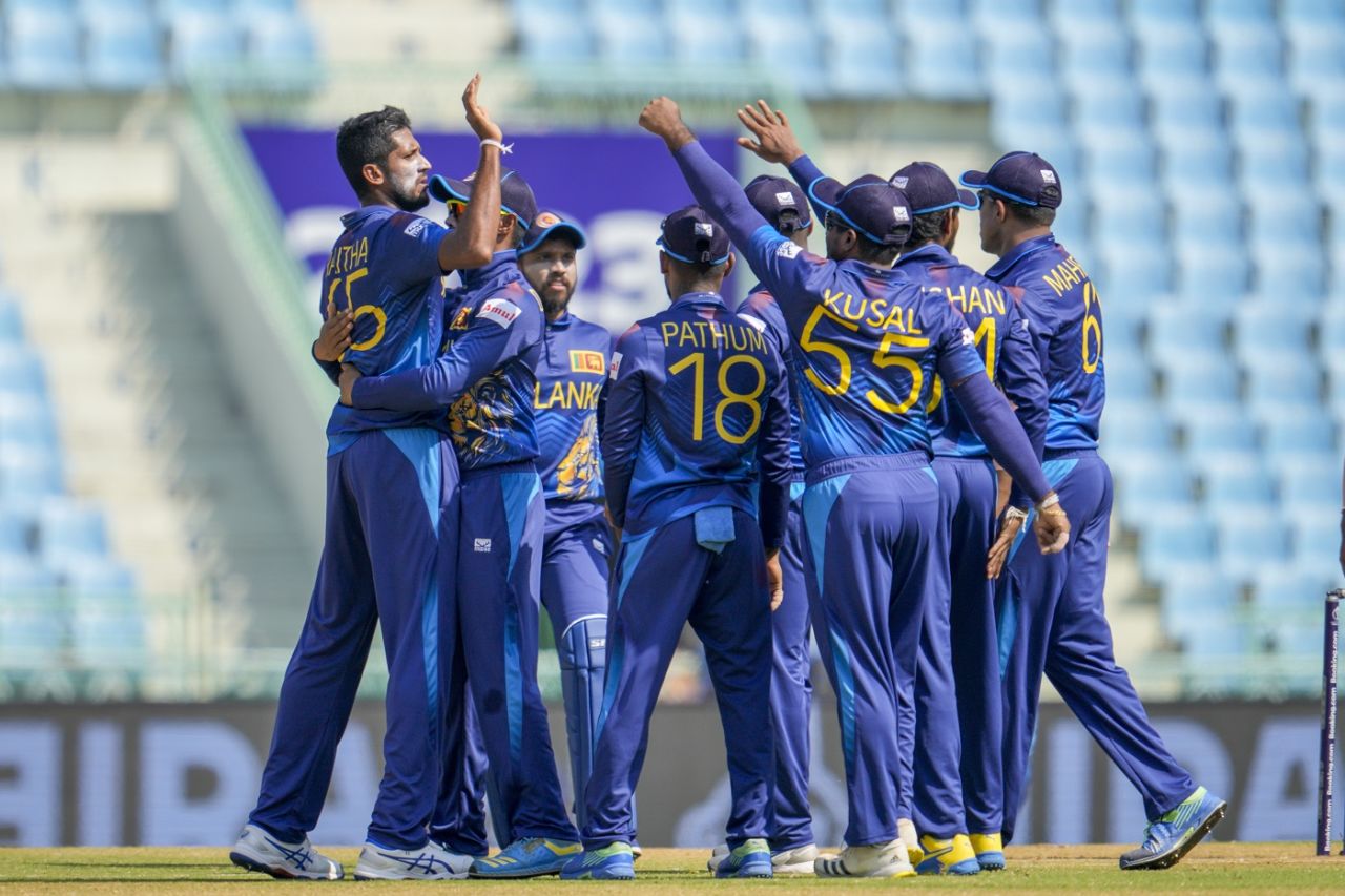 Kasun Rajitha and his team-mates get together after an early wicket ...