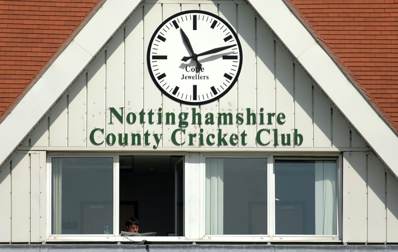 A scorer at Nottinghamshire County Cricket Club reads the paper from ...