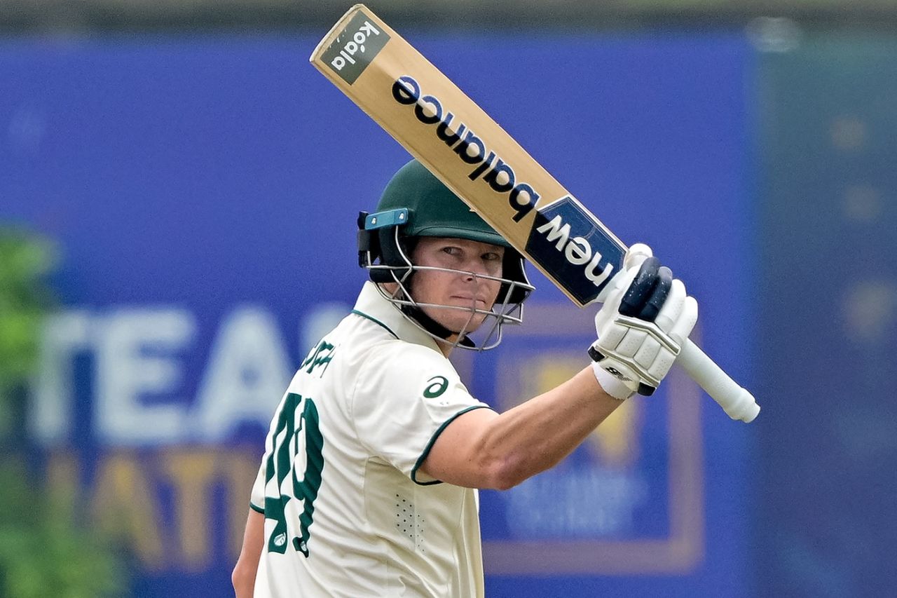 Steven Smith raises his bat after becoming the fourth Australian to ...