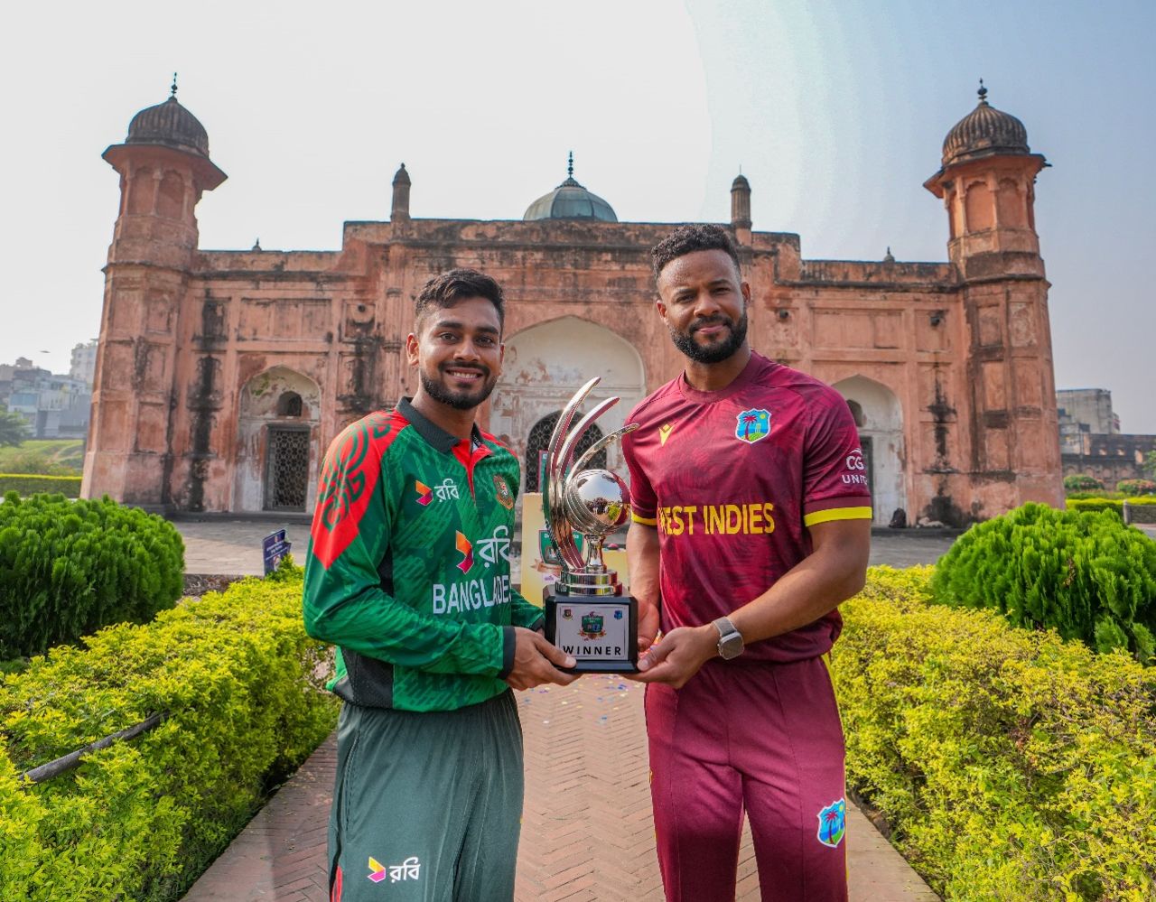 Mehidy Hasan Miraz and Shai Hope pose with the series trophy ...