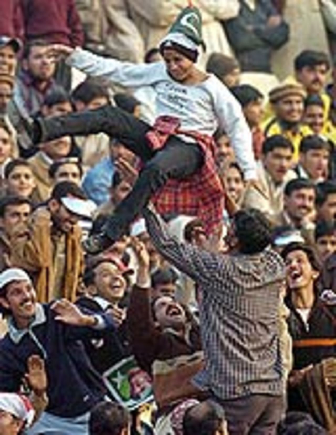 Pakistani fans lift a spectator | ESPNcricinfo.com