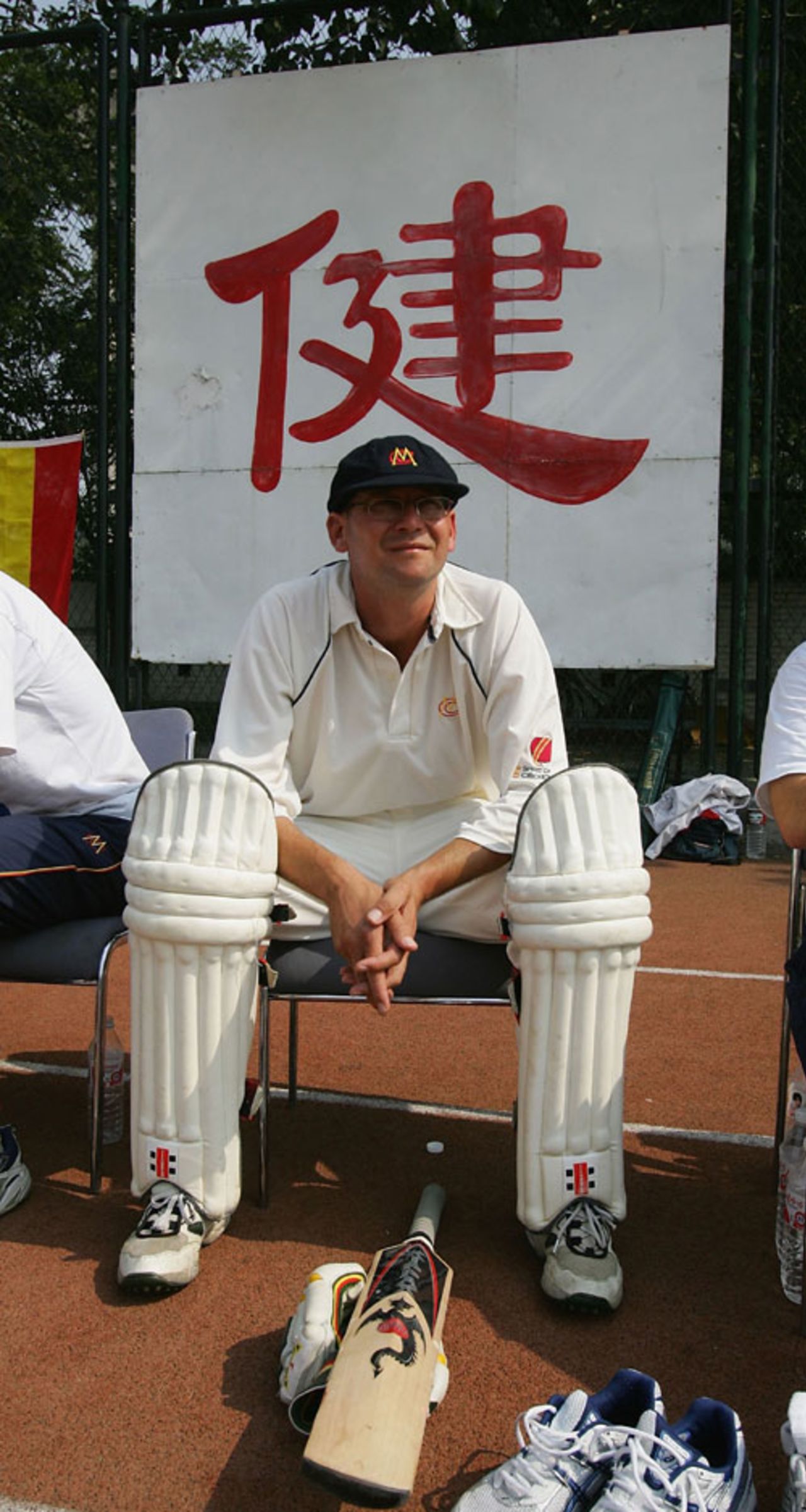 An MCC cricketer waits to bat against Shanghai Cricket Club ...