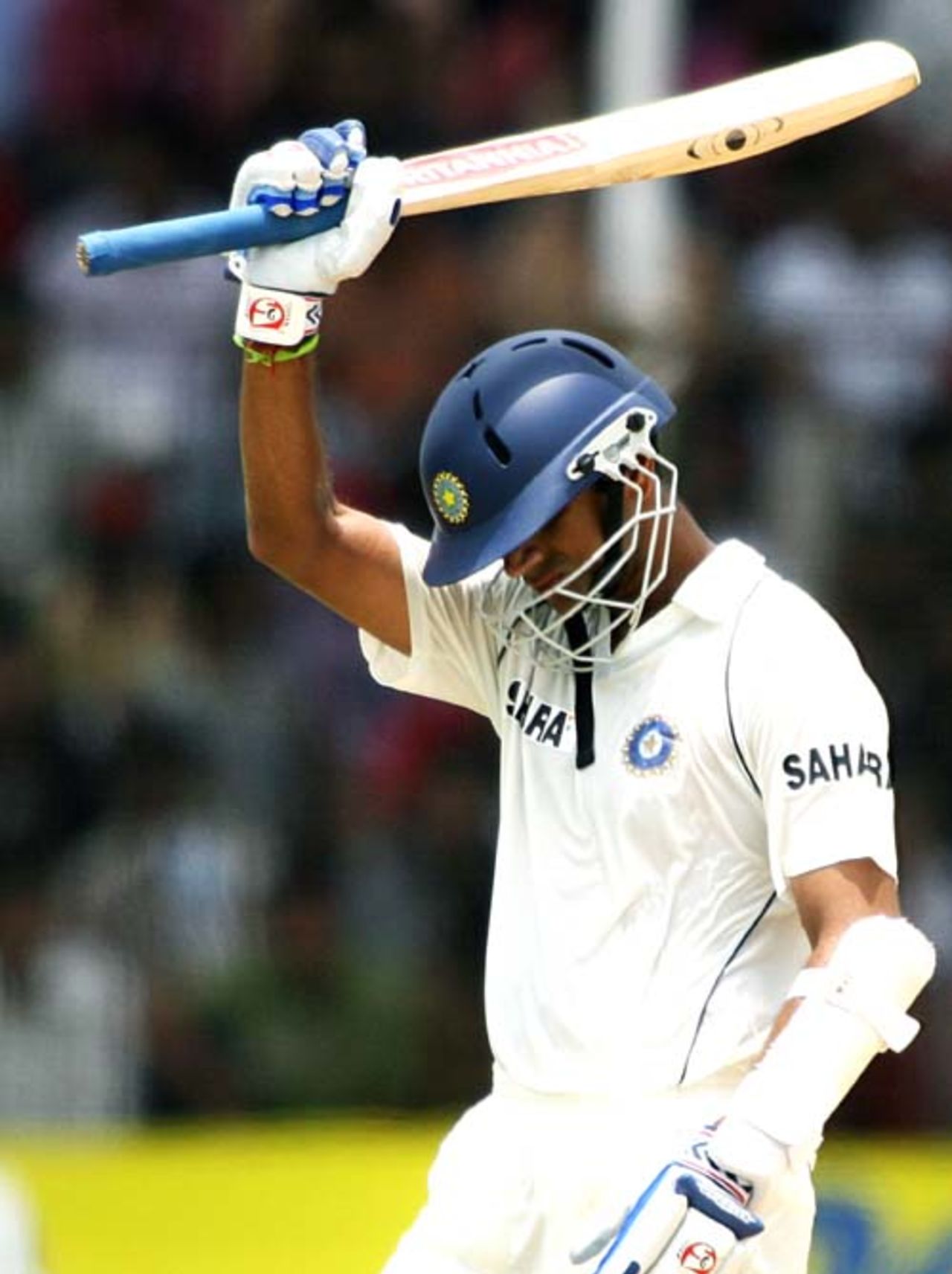 Rahul Dravid raises his bat on completing his half-century ...
