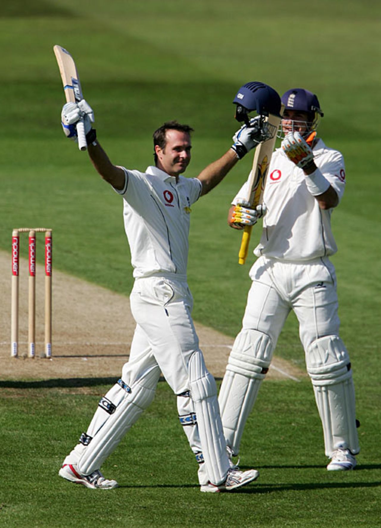 Kevin Pietersen celebrates his hundred as Daren Powell looks on ...