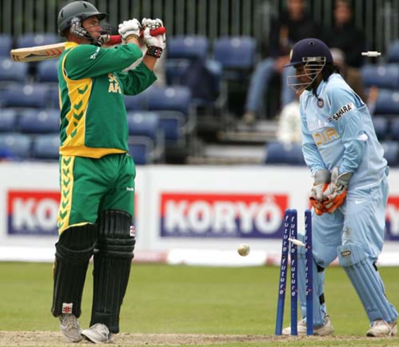 Andrew Hall has his stumps rearranged after attempting a wild pull shot ...