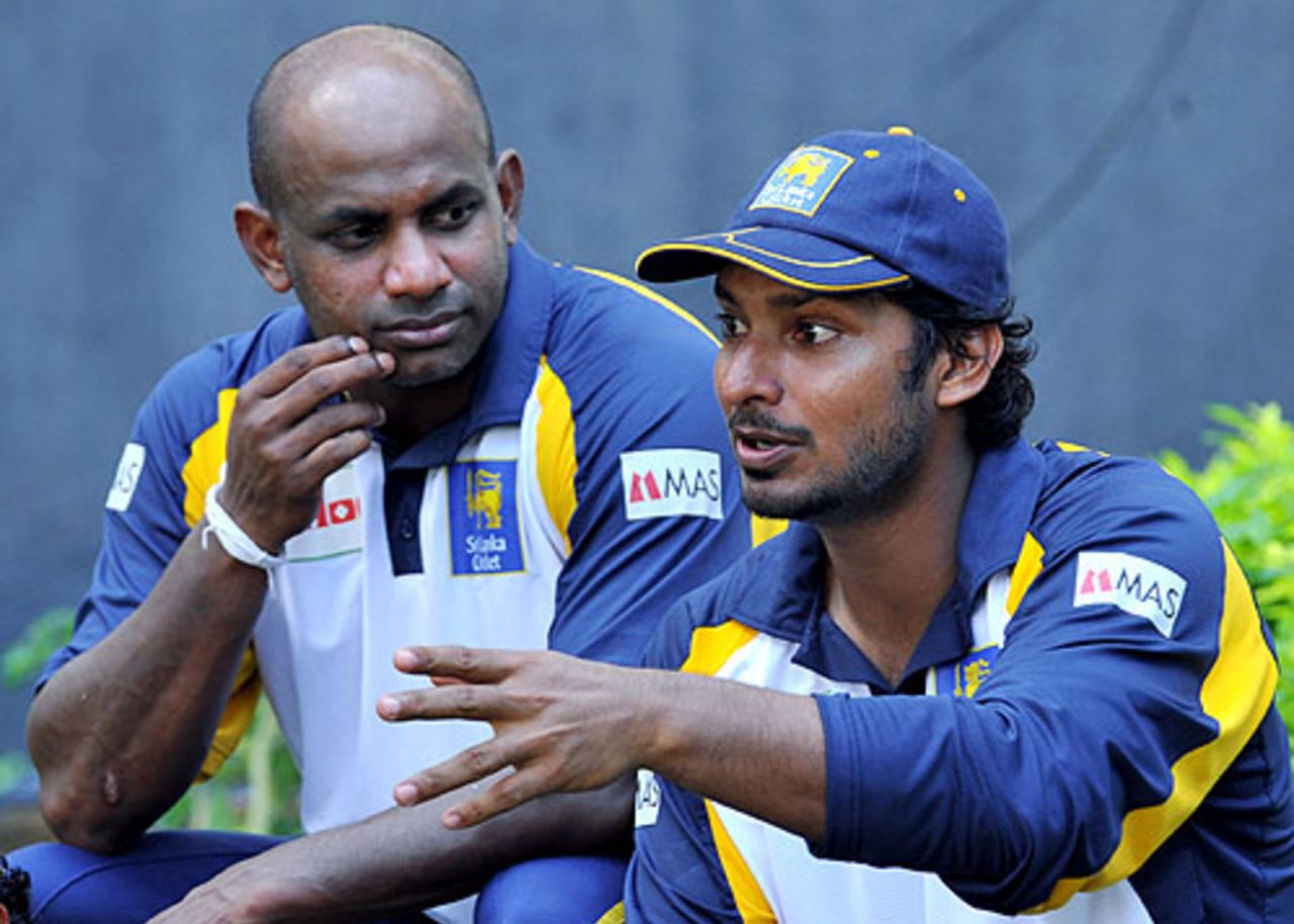 Sanath Jayasuriya listens while Kumar Sangakkara makes a point ...