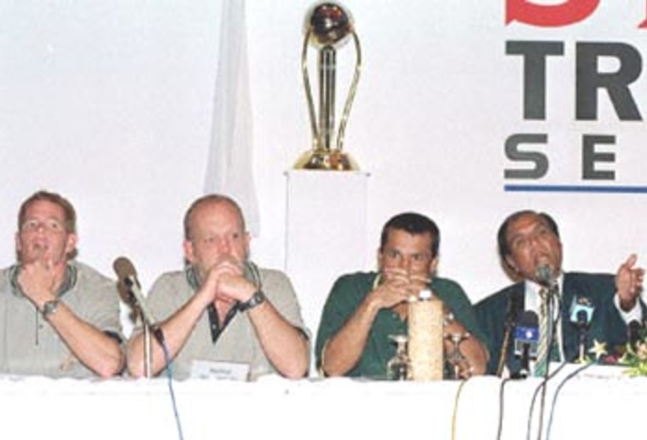 South African captain holding the Singer Trophy with Moin Khan and ...