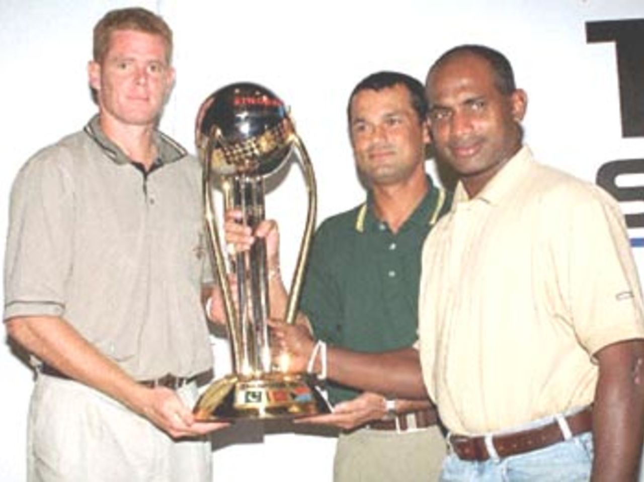 South African captain holding the Singer Trophy with Moin Khan and ...