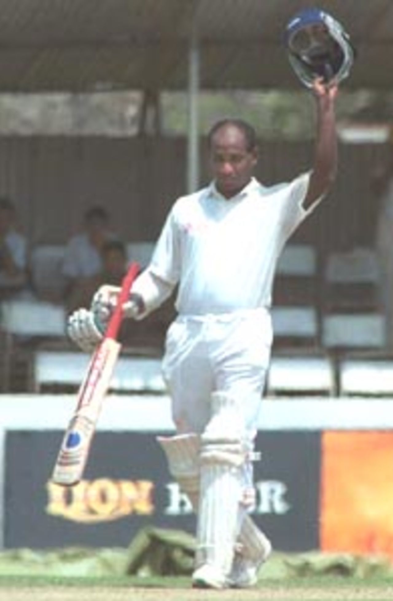Jayasuriya signals to the pavilion for a change of helmet ...