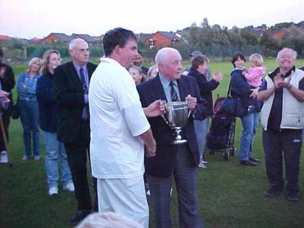 Skipper David Hayes receives the trophy from League President Arthur ...