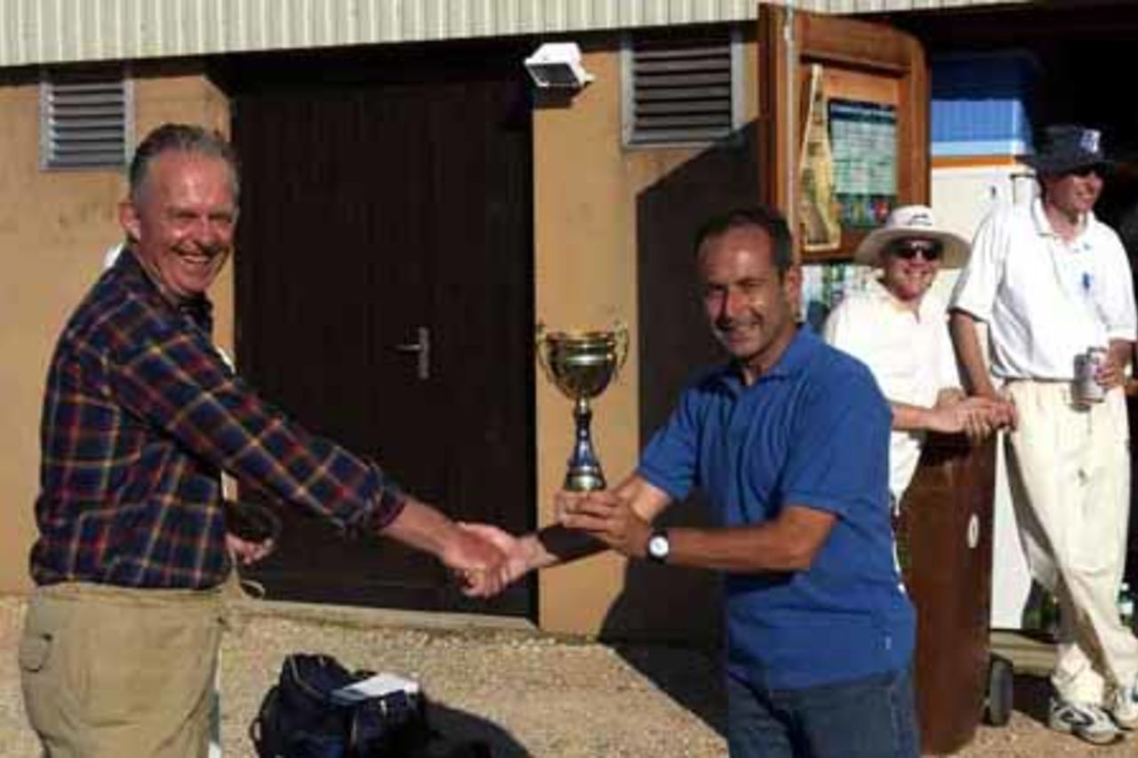 Bob Barber hands the trophy to winning captain Steve Best ...