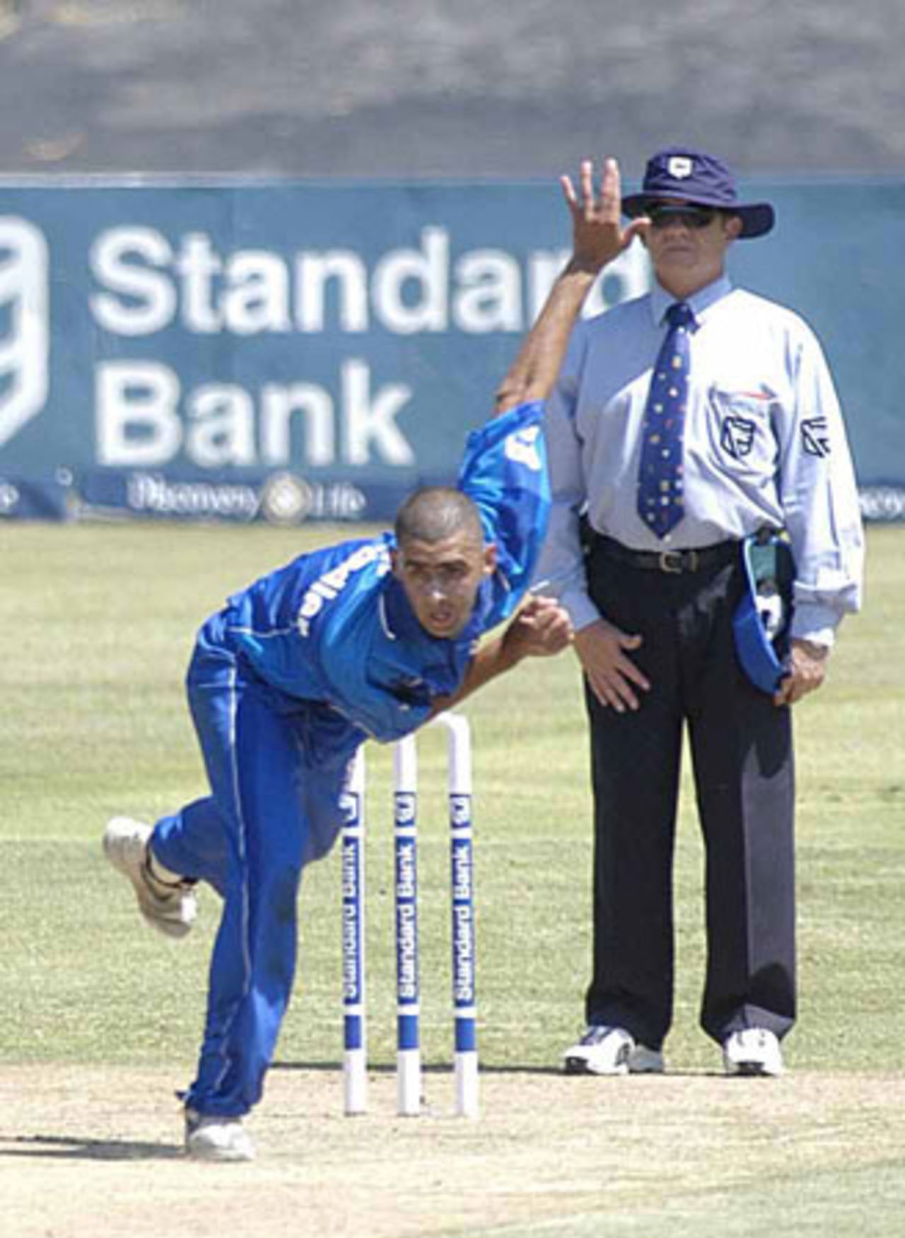 Marc de Stadler in his follow through with umpire Brian Jerling looking ...
